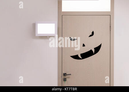 Wooden door with black angry scary monster face. Concept of phobia or ...