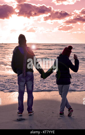 two people watching the sunset who goes to sleep in the sea Stock Photo ...