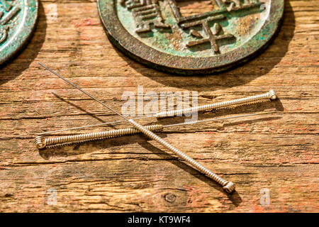 acupuncture needles with antique Chinese coin Stock Photo - Alamy