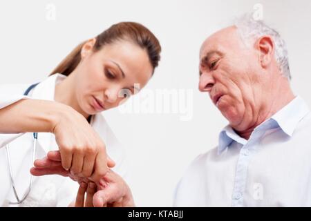 Nurse checking man's hand joints, close up Stock Photo - Alamy