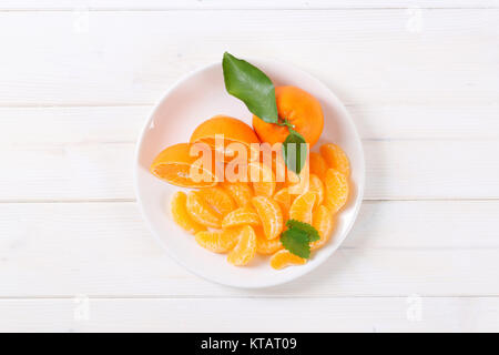 A top view of sliced and peeled tangerines with whole tangerines Stock ...