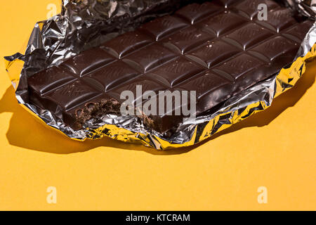 bitten chocolate candy in a candy wrapper Stock Photo - Alamy