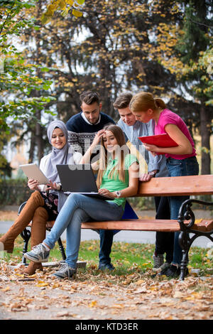 Multiethnic group of people studying together at table . Focus on ...