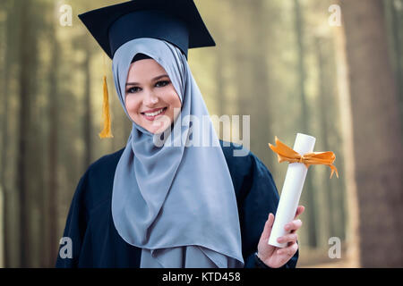 education, graduation and people concept - muslim woman in hijab with ...