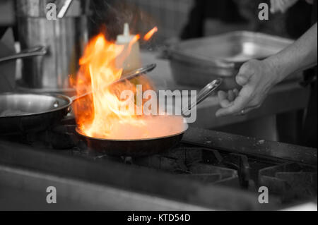 Flambe flame from a saute pan Stock Photo - Alamy