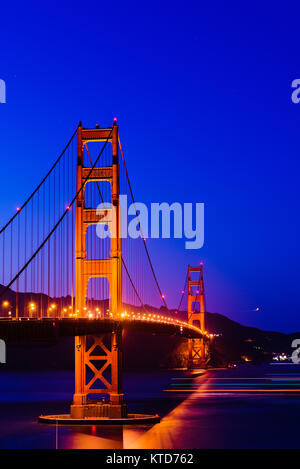 A vertical shot of the Golden Gate Bridge surrounded by clouds, San ...