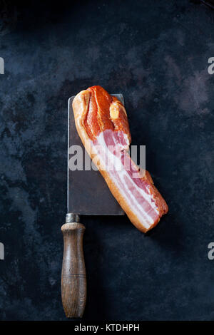 Streaky bacon with old cleaver on dark background Stock Photo - Alamy