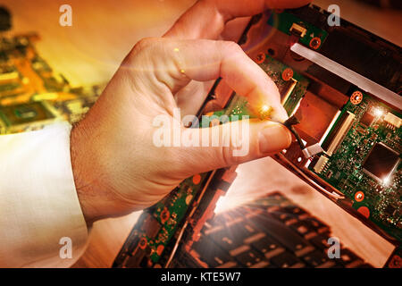 Tech fixes motherboard of laptop in service center Stock Photo - Alamy
