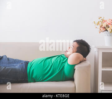 Fat man sleeping on the couch with his hand down his pants Stock Photo ...