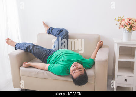 Fat man sleeping on the couch with his hand down his pants Stock Photo ...