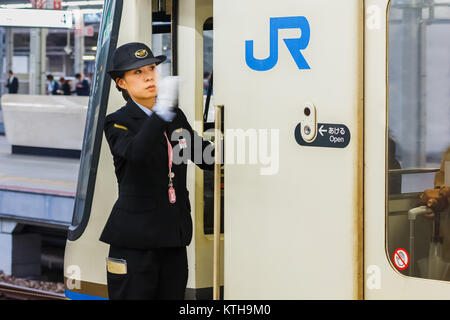 Female train driver in uniform checks her schedule before entering the ...