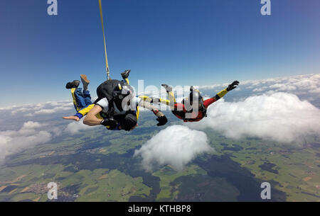 This tandem skydiving couple, plus the fun jumper are enjoying the ...
