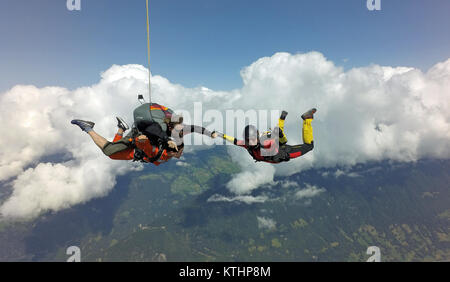 This tandem skydiving couple, plus the fun jumper are enjoying the ...