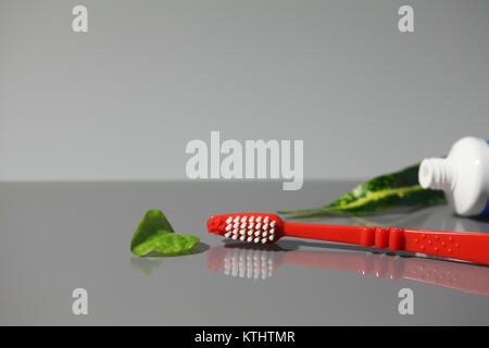 A tube of toothpaste, with white, green and red striped toothpaste on a ...