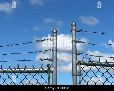 Barbed wire fence used for protection purposes Stock Photo - Alamy