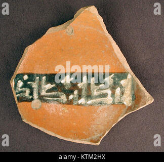 This artifact, a base of a vessel with a white slip inscription, is ...