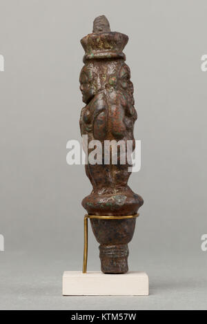 The image depicts Bes, an ancient Egyptian deity, carrying a ram over ...