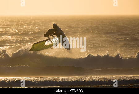 Boardsailing in the sunset in high winds Stock Photo - Alamy