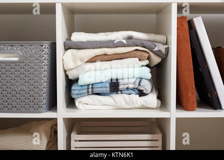 white rack with shelves full of stuff Stock Photo - Alamy