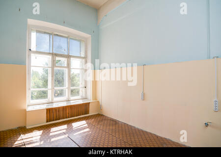 Creepy abandoned office room inside with old wooden table and windows ...