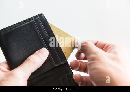 Man with wallet and credit cards using laptop in bedroom, closeup Stock ...