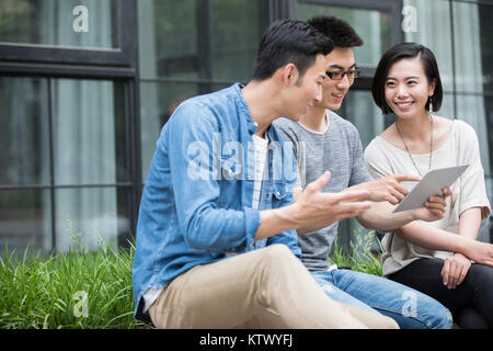 Confident designer team talking outdoors Stock Photo - Alamy