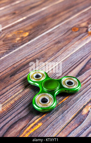 Green fidget spinner close up, stress relieving toy isolated on white ...