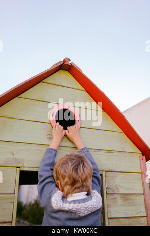 Children playing by a wooden green hut of a playground in Hortulus ...
