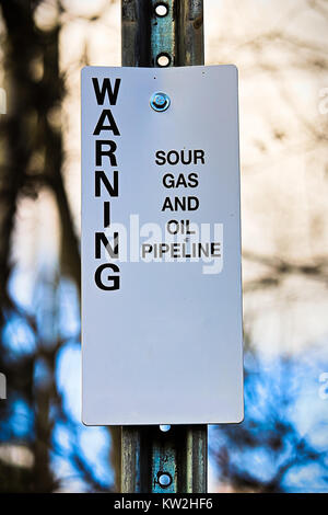 Warning sour gas and oil pipeline sign Stock Photo - Alamy