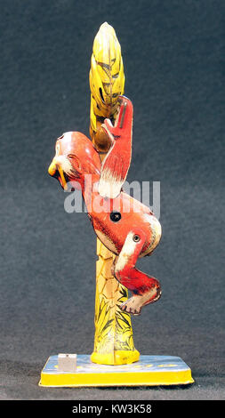 An image of Bombo, a tin toy monkey placed in a tree. The toy, popular ...