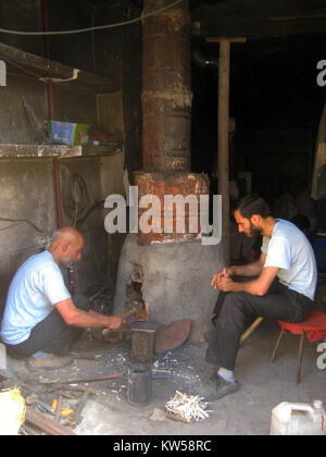 This image depicts a blacksmith working in Nishapur, an ancient city in ...