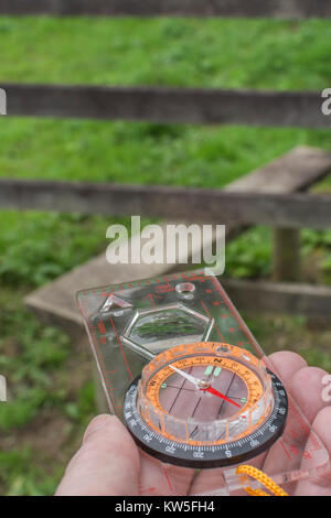 Orienteering compass in hand - for business 'direction', navigation ...
