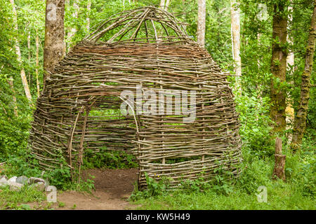 Tiny cottage made of wooden sticks in woods, hovel, shelter for small ...