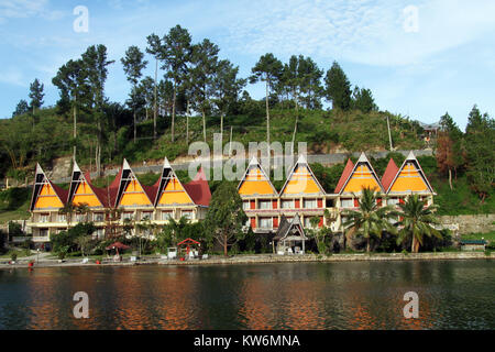Batak Toba village houses with high ended roof and tribal carvings ...