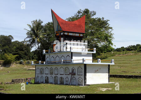 Traditional batak grave on the green field on the Samosir island ...