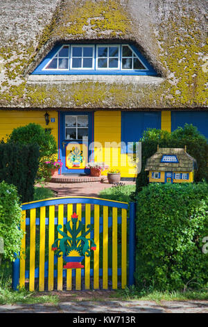 Colourful thatched-roof house with postbox (miniature replica of house ...