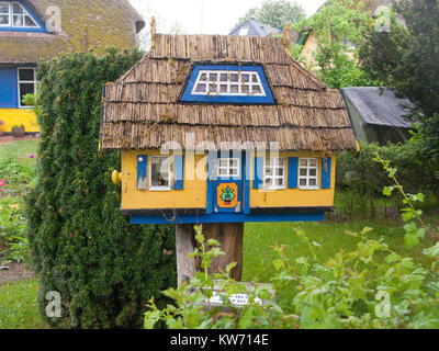 Colourful thatched-roof house with postbox (miniature replica of house ...