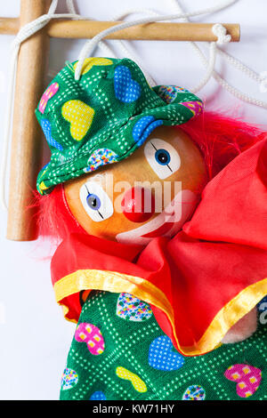 Clown puppet with strings set on white background Stock Photo - Alamy