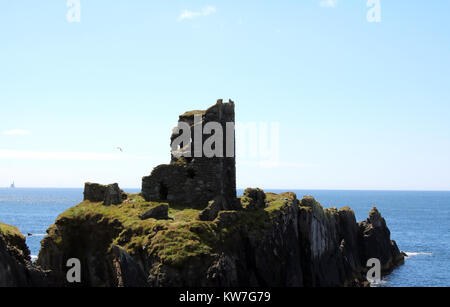 Old Irish Castle balancing on the cliffs of the Coastline overlooking ...
