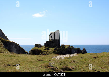 Old Irish Castle balancing on the cliffs of the Coastline overlooking ...