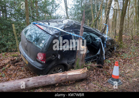 A crashed car, a black Volkswagen Polo, in a country lane surrounded by ...