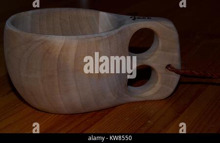 Traditional Finnish wooden drinking cup called guksi or kuksa, white ...