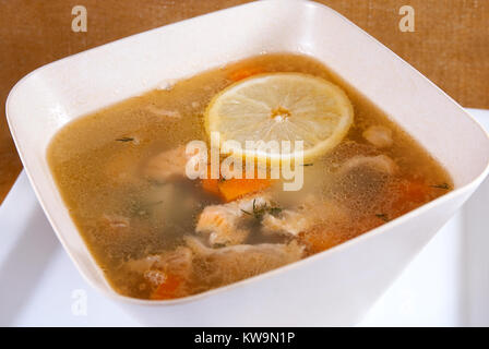 Fish soup with slice of lemon. Close up image Stock Photo - Alamy