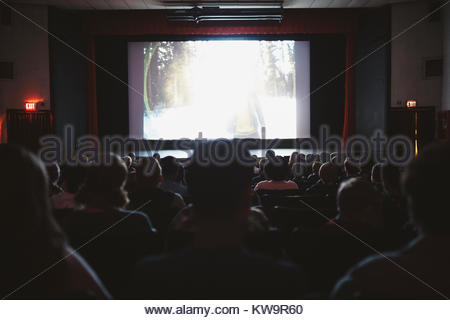 Rear view of theater audience watching performers on stage Stock Photo ...