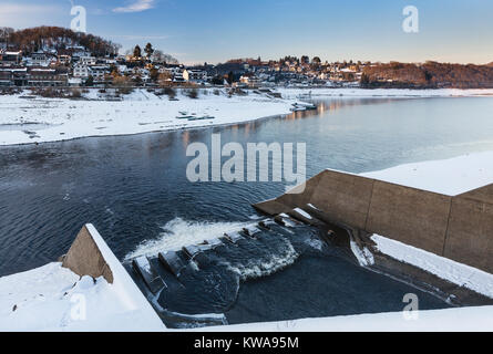 Evening view over lake Rursee to the village of Rurberg with snow in ...