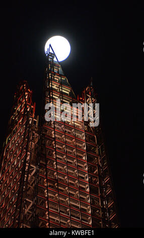 supermoon, also known as the wolf moon in the cloudy sky at night Stock ...