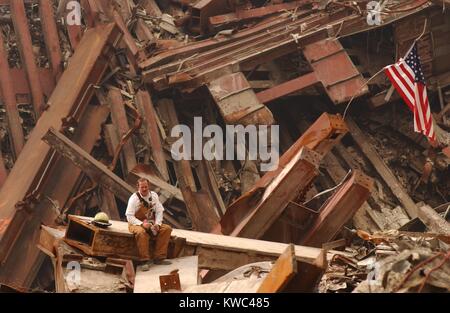 Solo firefighter sitting on a beam in the wreckage of the World Trade ...