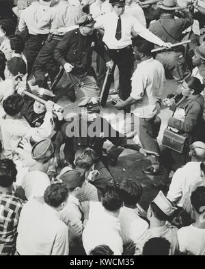 Two lines of police hold back rioters, allowing attendees of the Paul ...