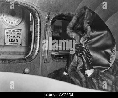 Mae Capone, wife of gangster Al Capone, hides her face from ...
