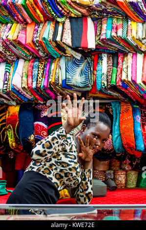 Shop assistant in an African-syle boutique, shopping mall, Kampala ...